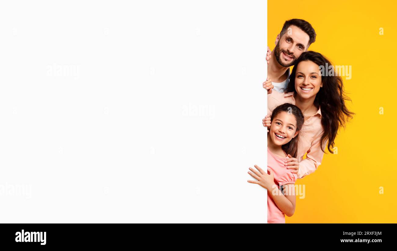 Family offer. Excited european parents and their daughter peeking out ...