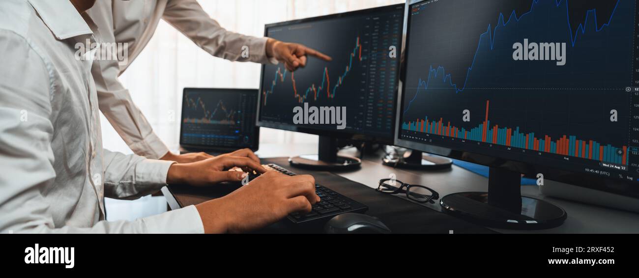 Group of traders discussing on office desk, monitoring stock market on ...