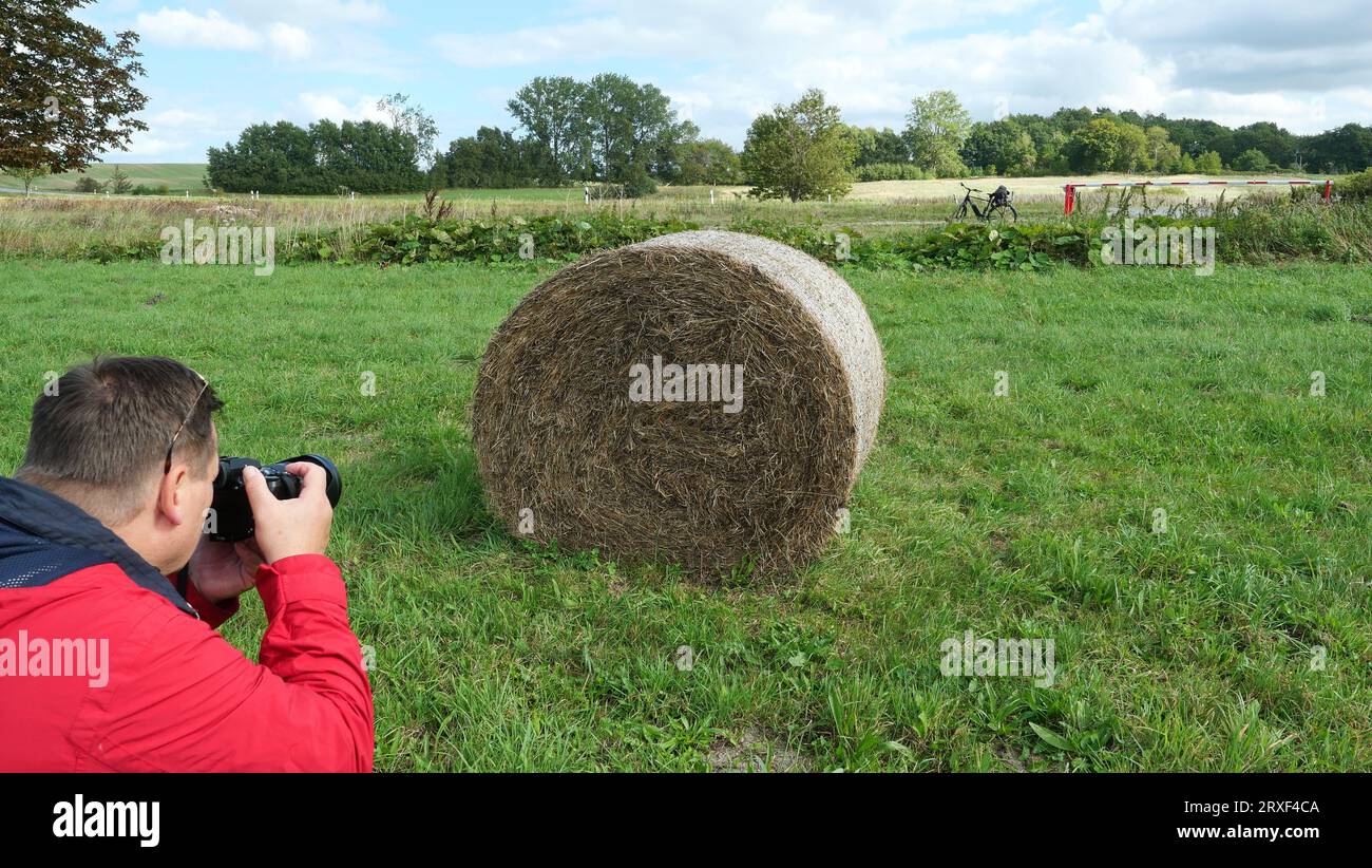 A photographer chooses the round hay bale as a subject because of its ...