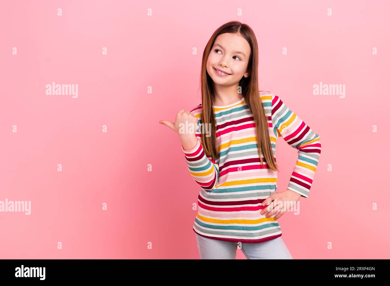 Photo of confident young little kid girl directing finger promoting ...