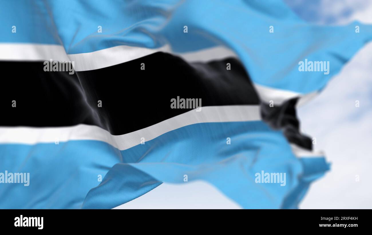 Close-up of Botswana national flag waving on a clear day. Light blue ...