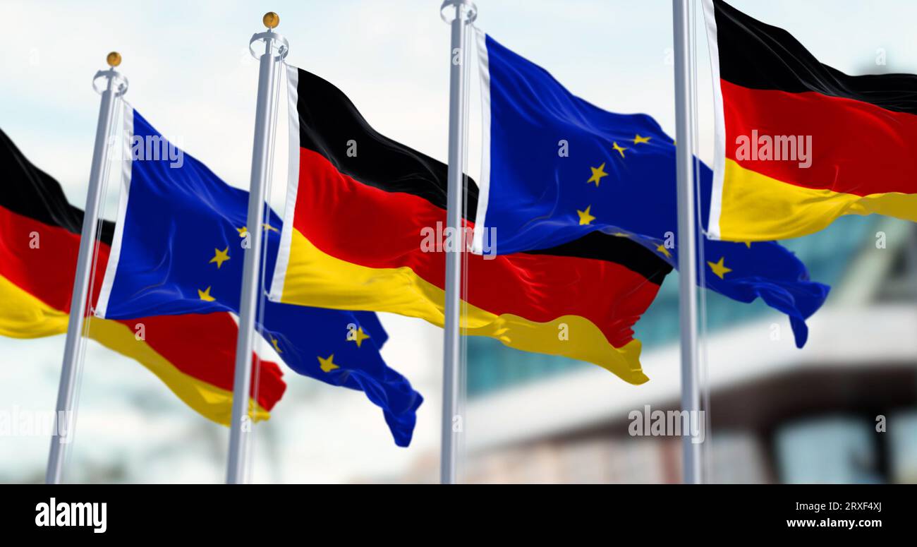 Flags of Germany and the European Union waving in the wind on a clear ...