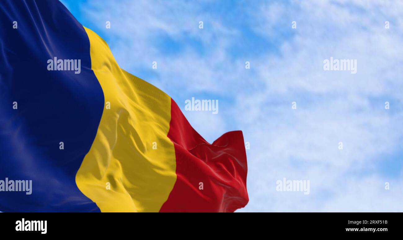 National flag of Romania waving in the wind on a clear day. Three ...