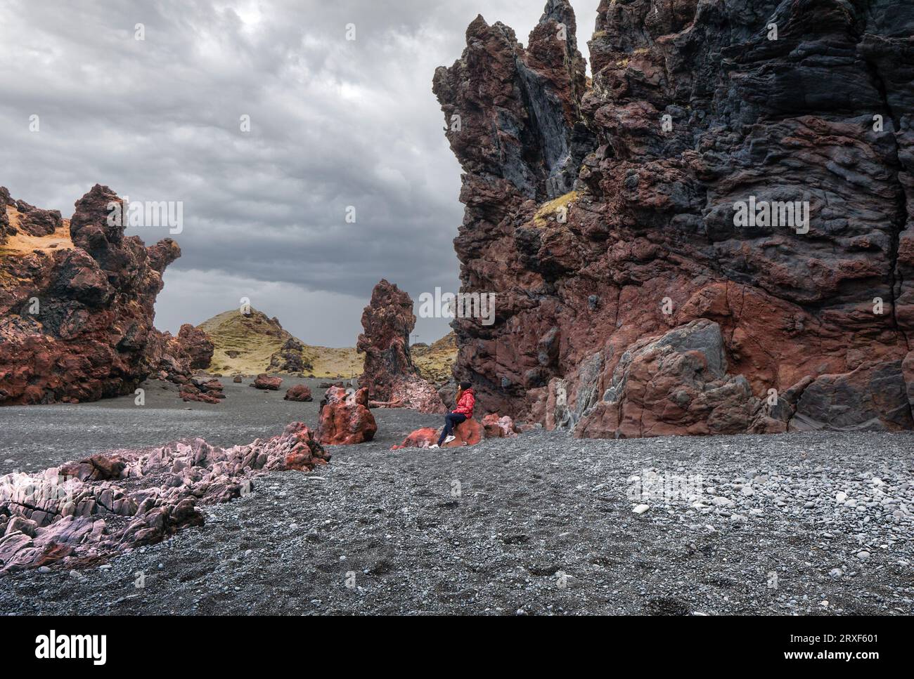 Amidst Djúpalónssandur's ancient stones, a muse emerges, merging ...
