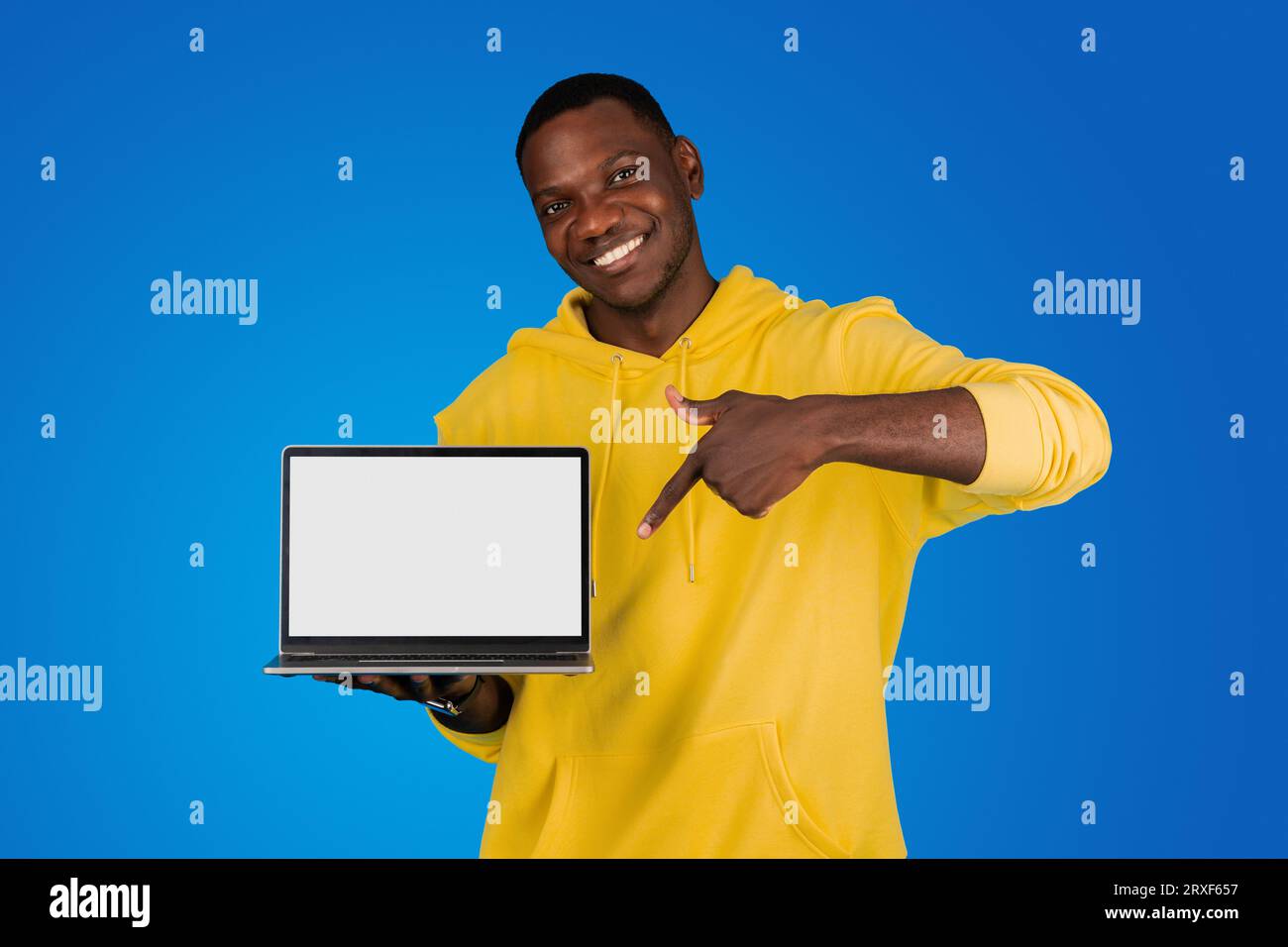 Smiling young black man point finger at laptop with empty screen Stock ...