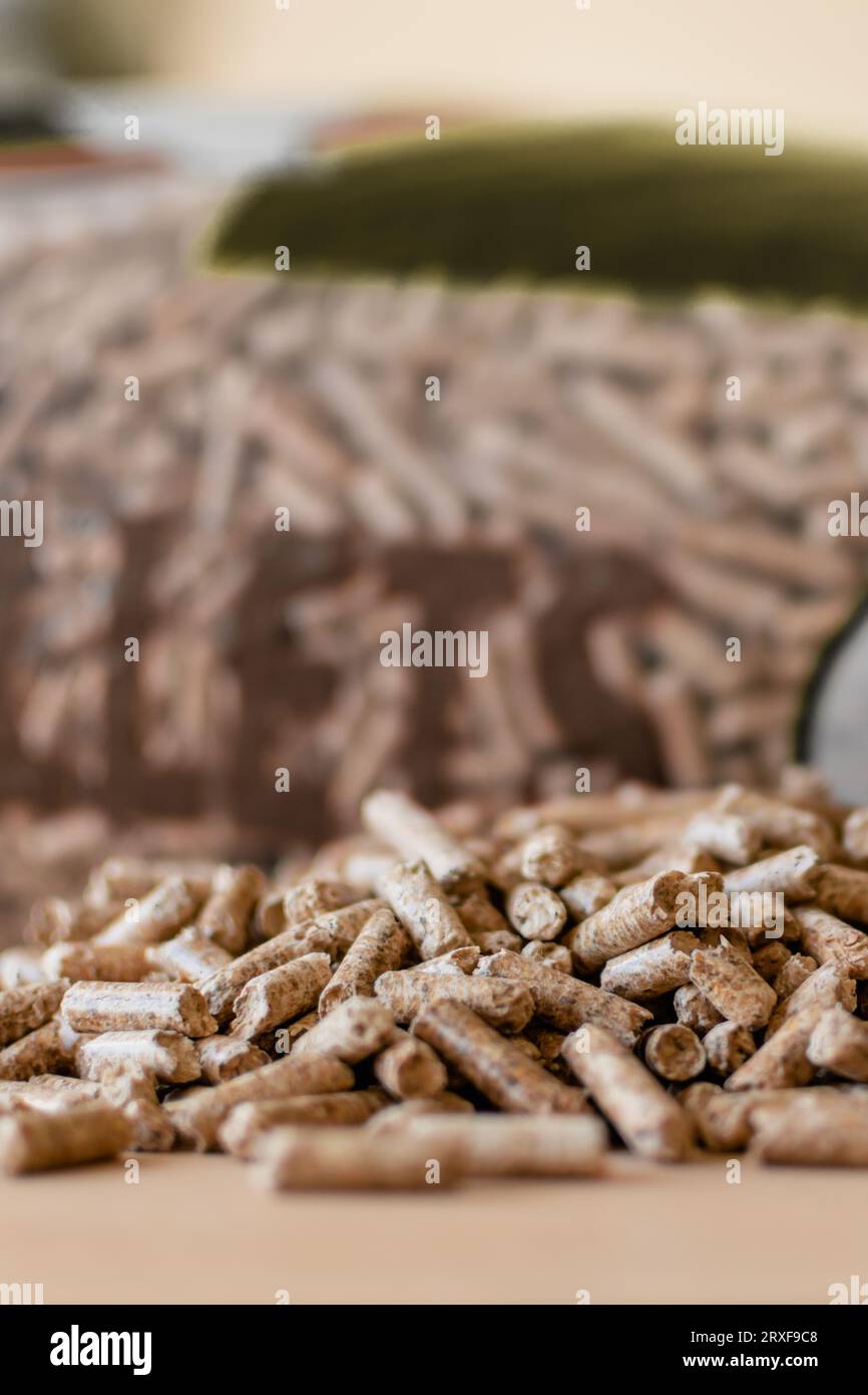 Pile of pellets with bag of granules in the background Stock Photo - Alamy