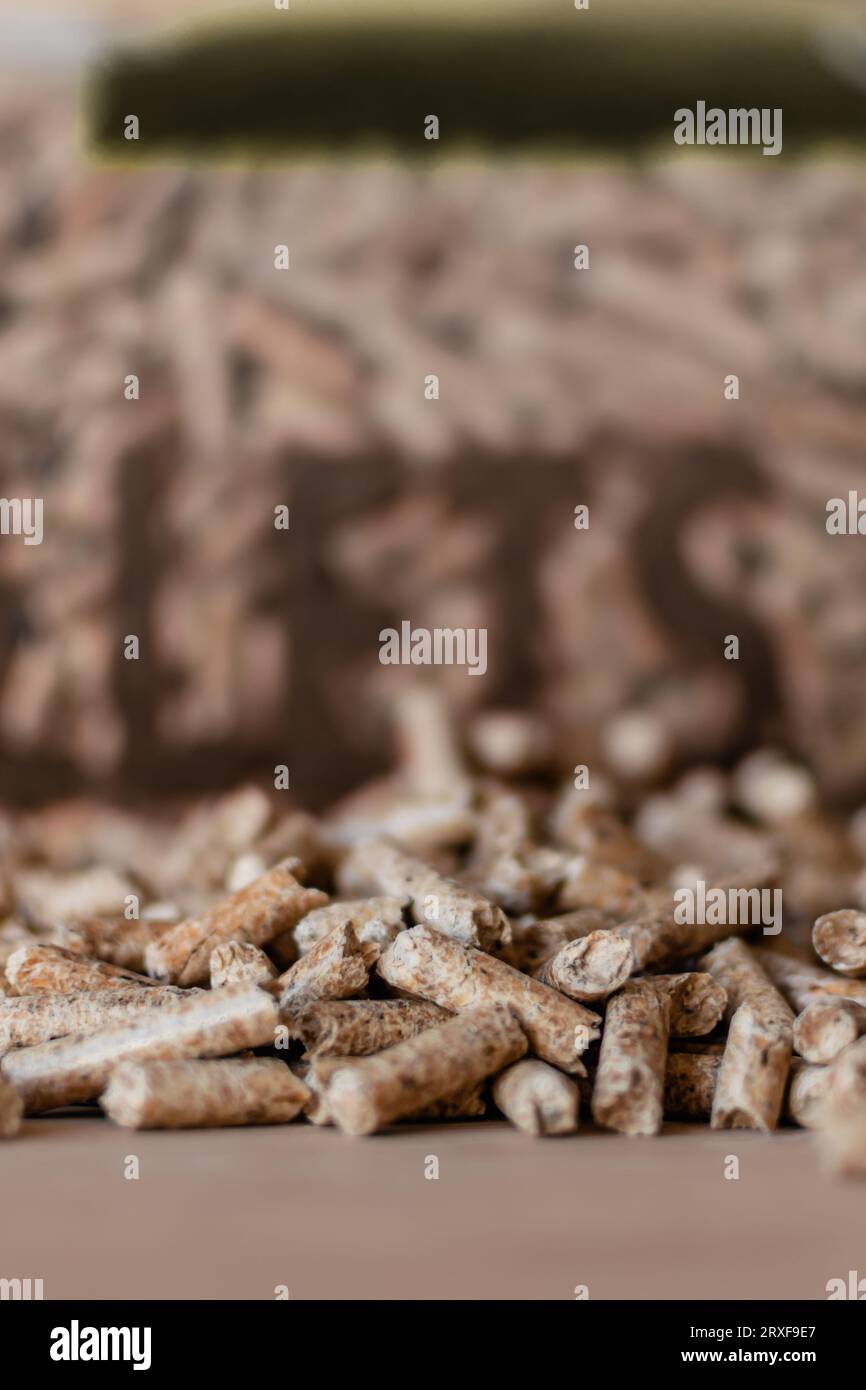 Pile of pellets with bag of granules in the background Stock Photo - Alamy