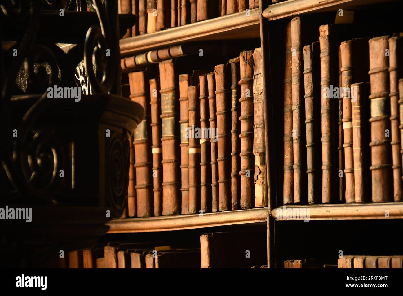 Old books on the shelves inside the Old library in Trinity College ...