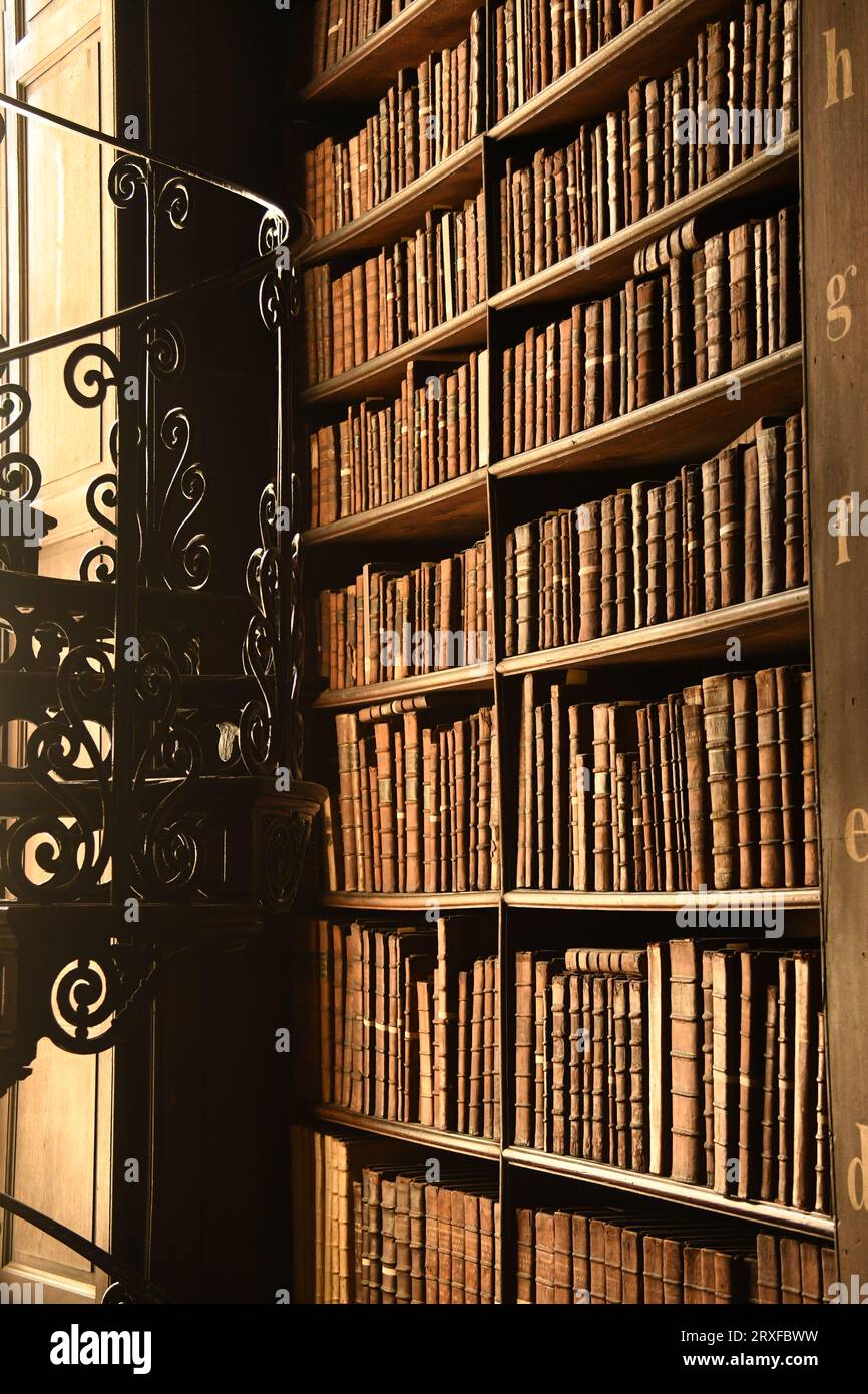 Old books on the shelves inside the Old library in Trinity College ...