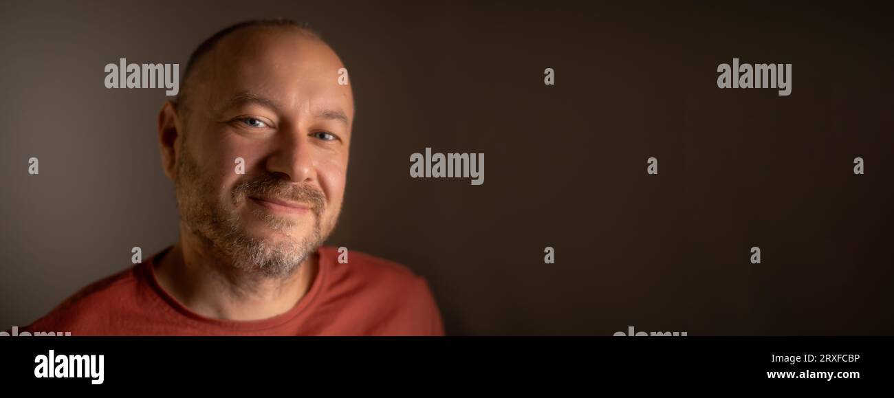 Unshaven middle-aged man, about 40 years old, wearing approachable ...