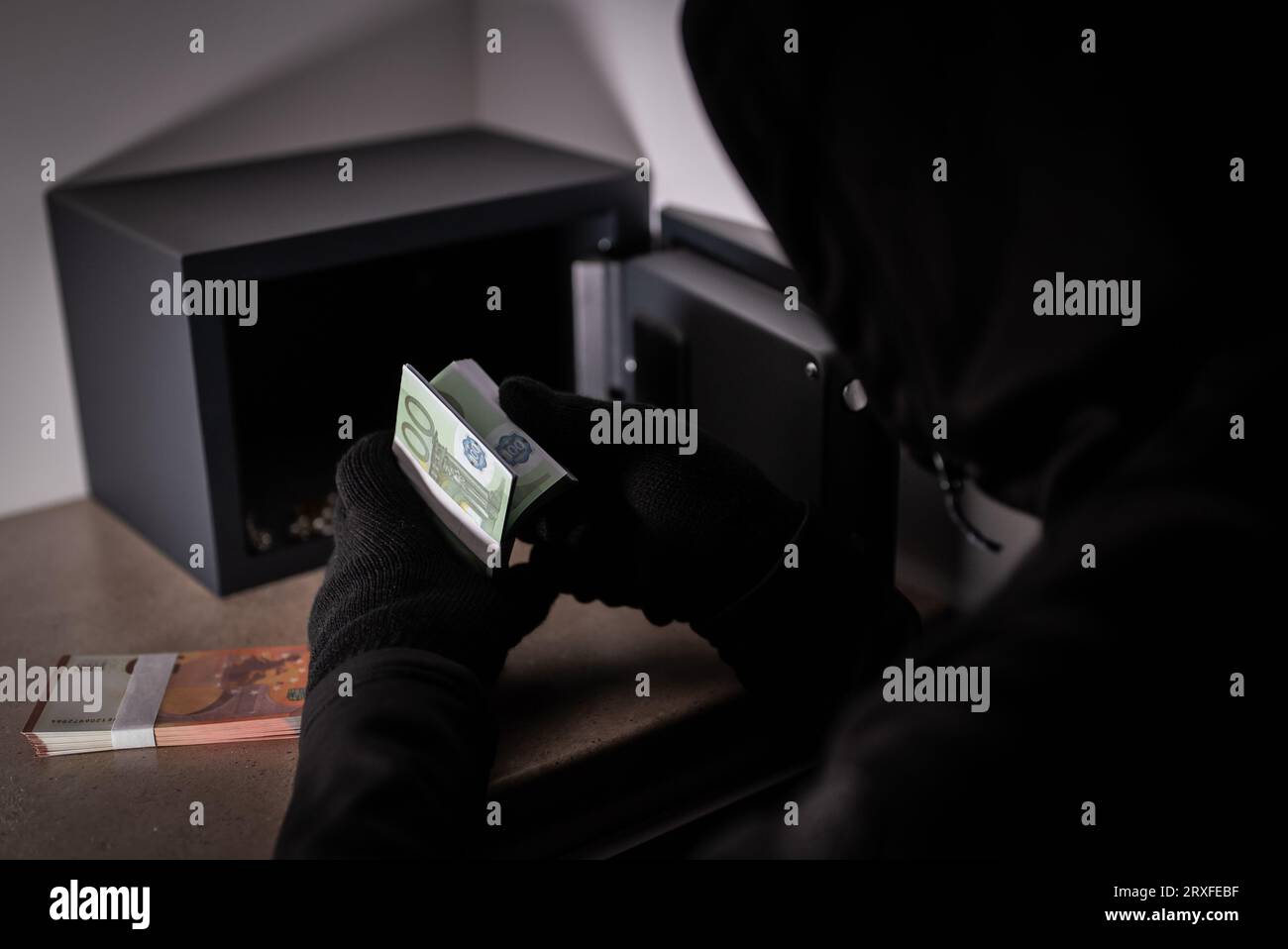 Thief steals money from a steel safe Stock Photo - Alamy