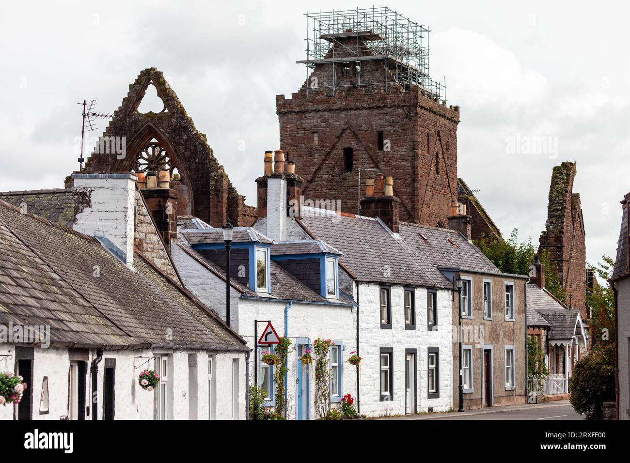The village of New Abbey with Sweetheart Abbey towering above the small ...