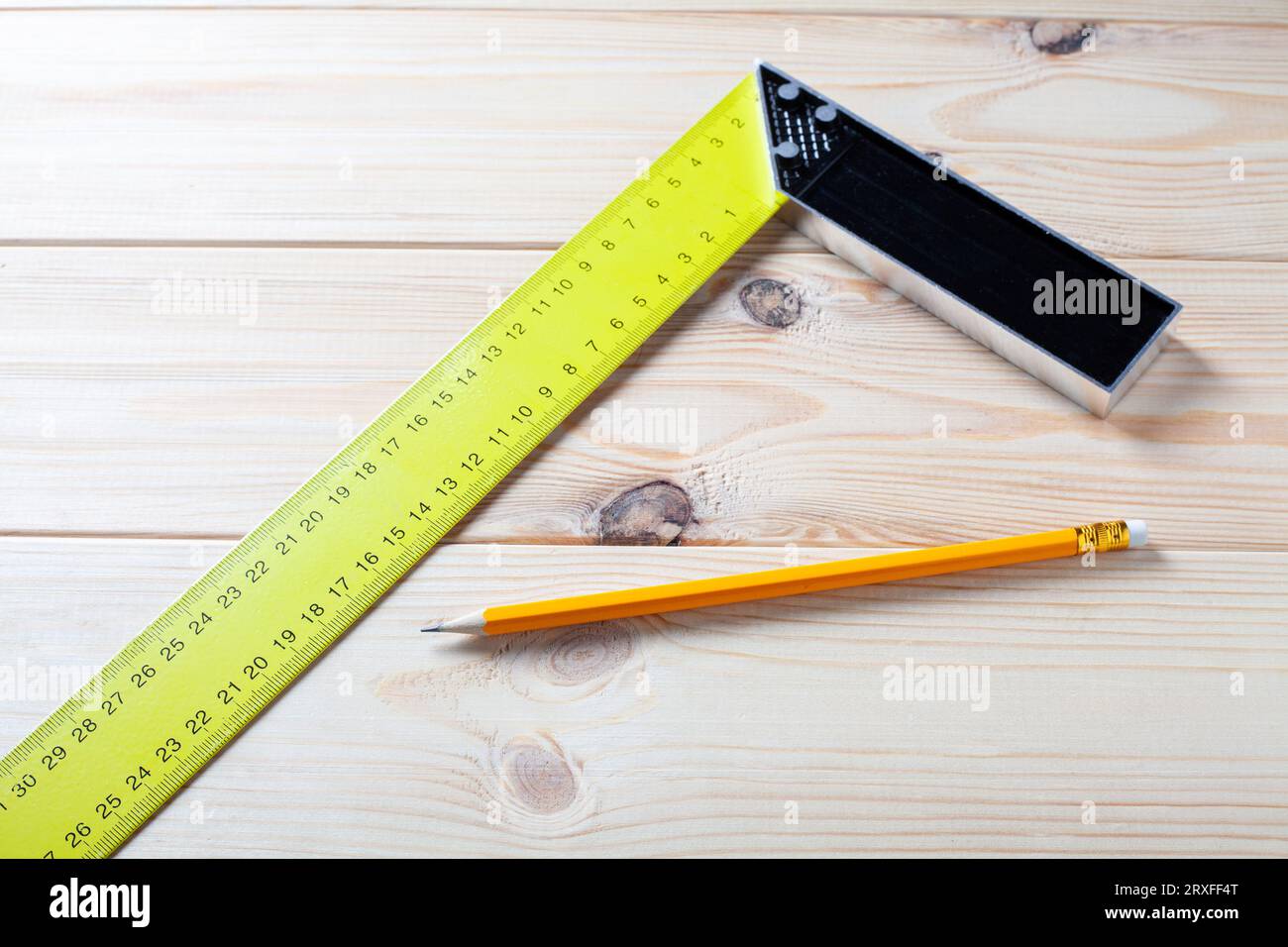 Square ruler and pencil for measuring on wooden board. construction ...
