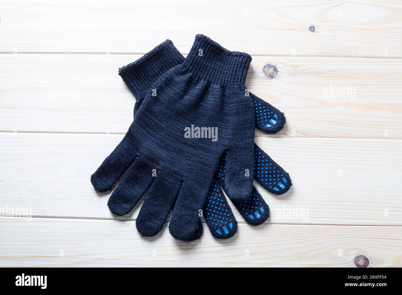 pair of black working gloves with rubber dots Stock Photo - Alamy