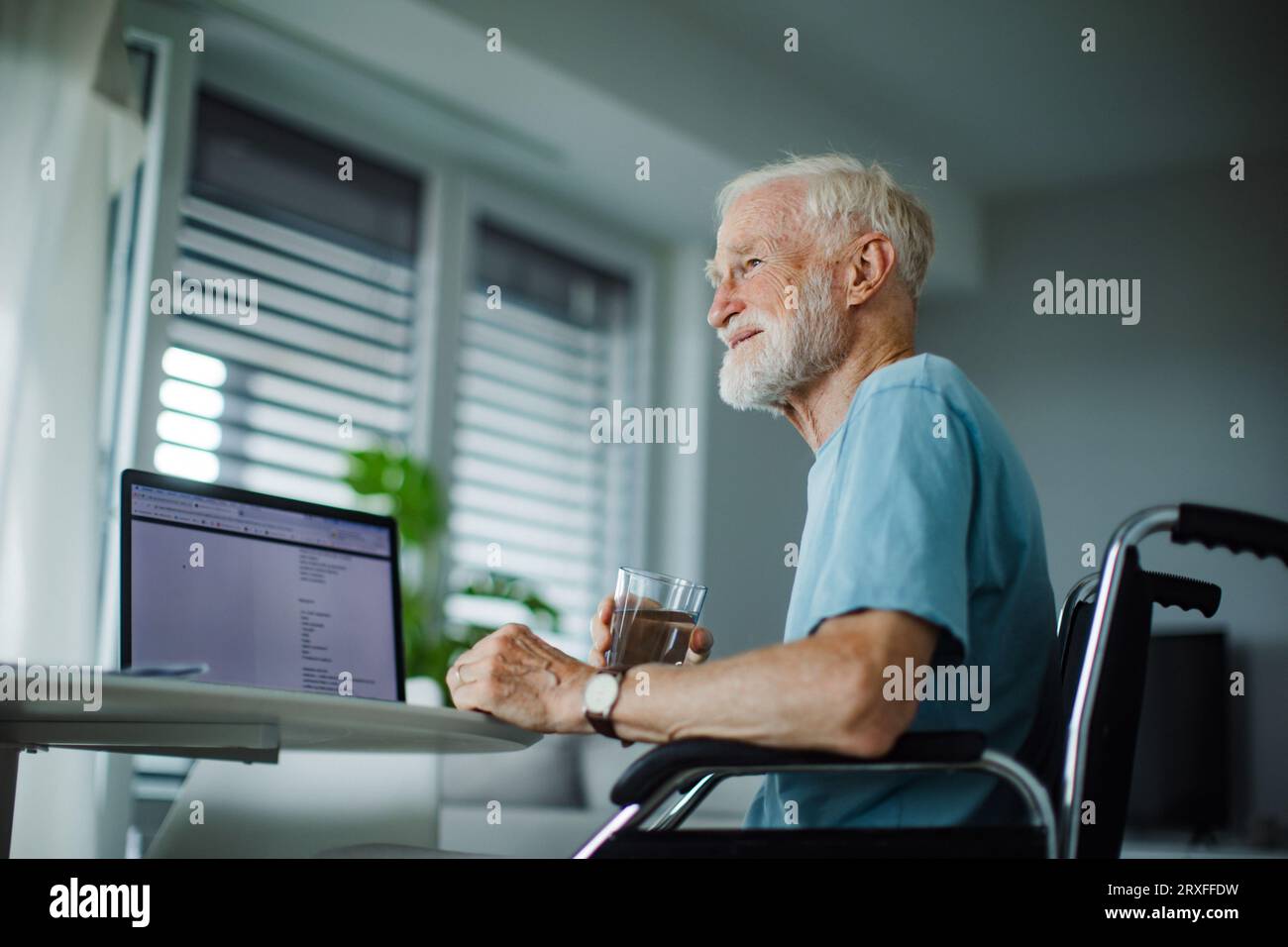 Senior man in a wheelchair working during retirement Stock Photo - Alamy