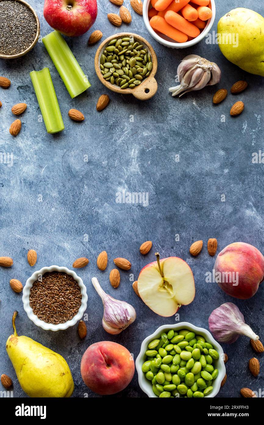 An assortment of healthy whole foods with copy space in the middle ...
