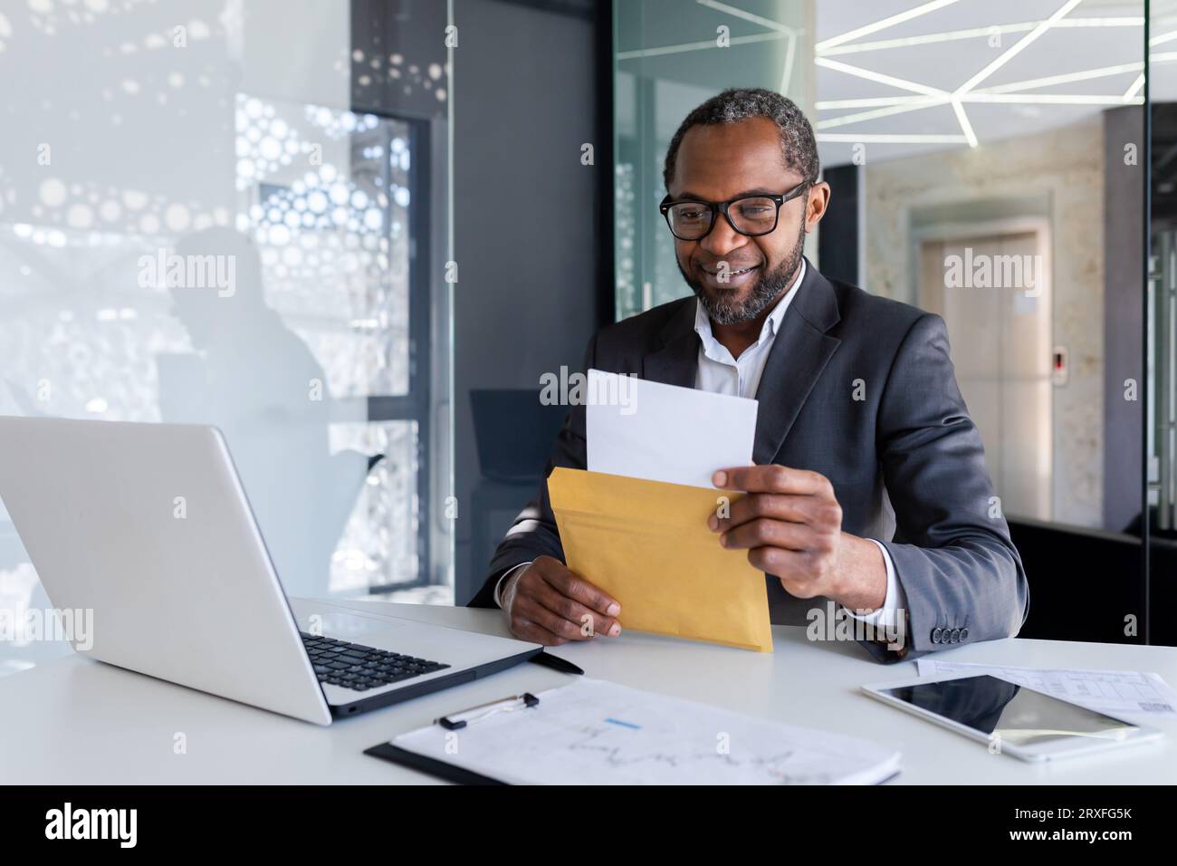 Senior satisfied financier received a letter mail message in an ...