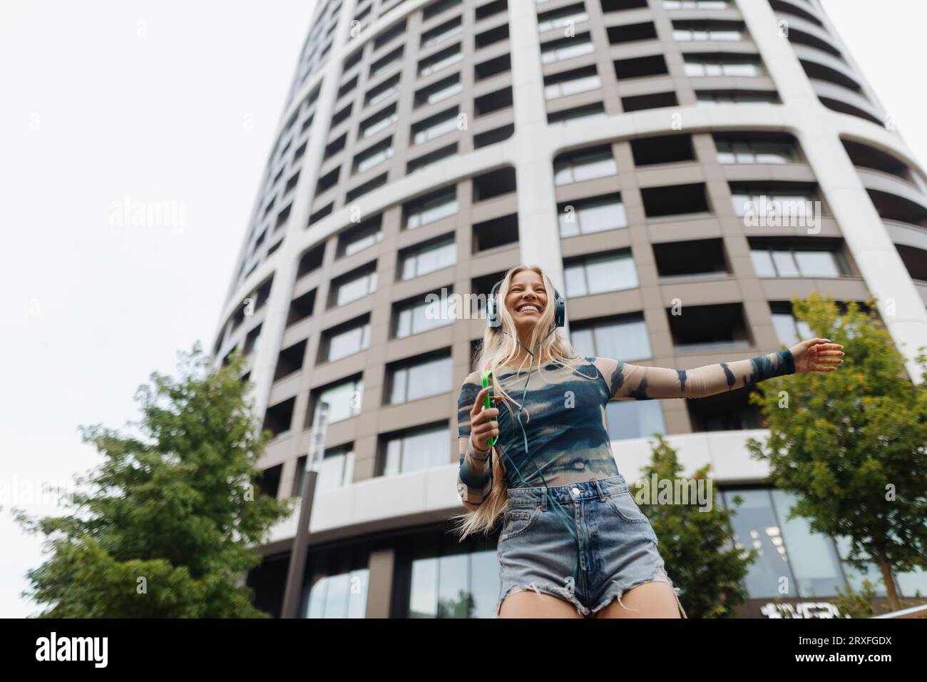 Portrait of stylish generation z girl student outdoors in the city ...