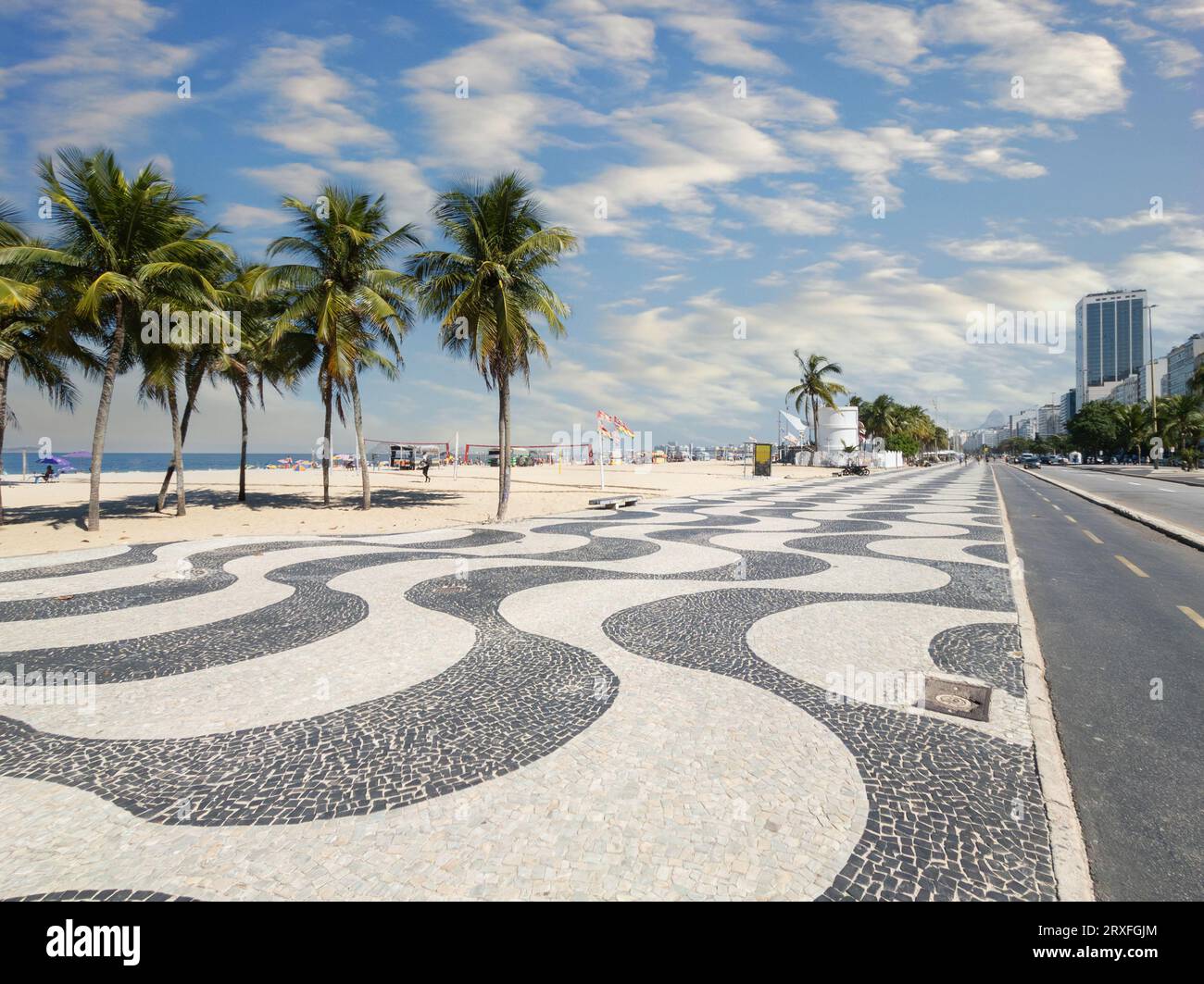 Famous Boardwalk on Copacabana Beach and coconut trees with blue sky in ...