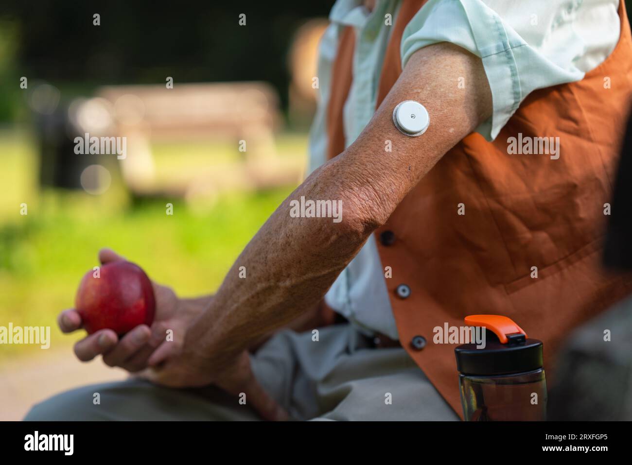 Close up of senior man with sensor of continuous glucose monitor on his ...