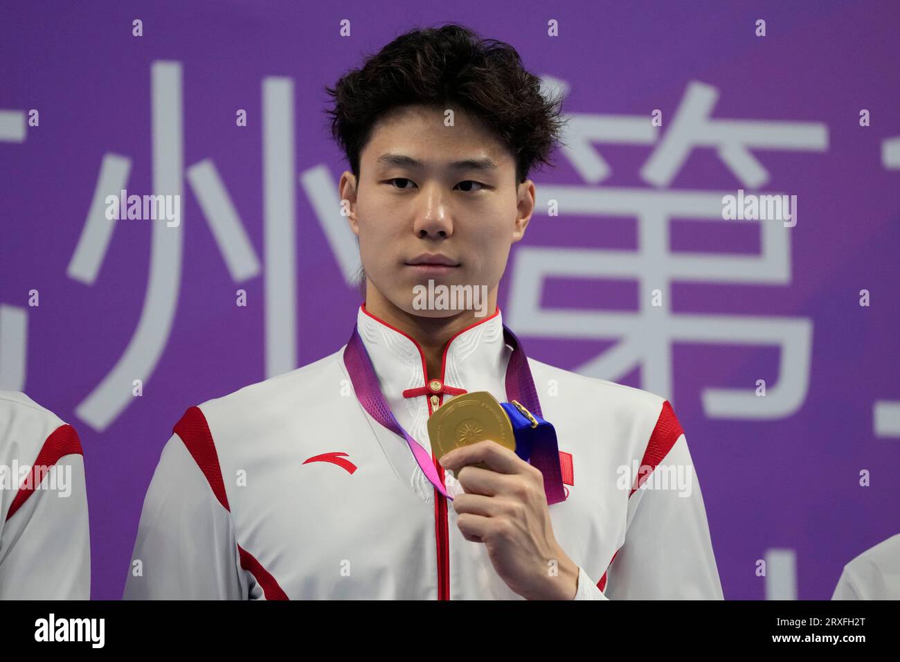 Gold medalist Qin Haiyang of China celebrates on the podium during the ...