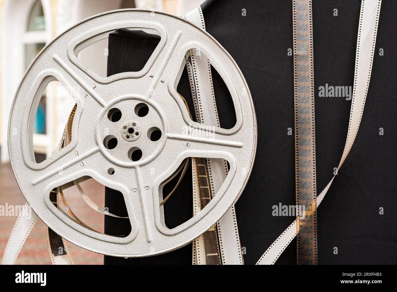 Old Film stock, strip. Old Film reel, bobbin, spool against a dark ...