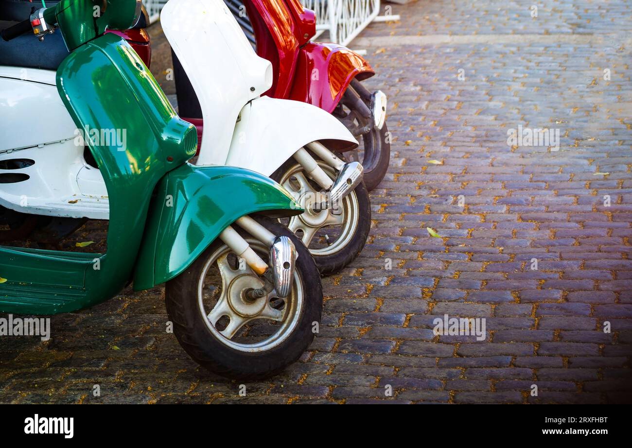 Italian style vintage scooter parked on sidewalk.Vintage scooters on a ...
