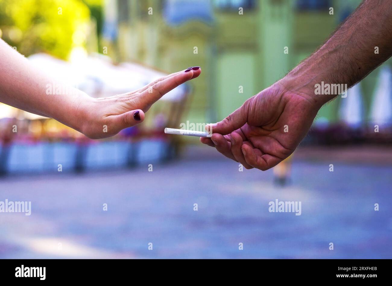 The man suggests the woman to smoke! The social problem. the man offers ...
