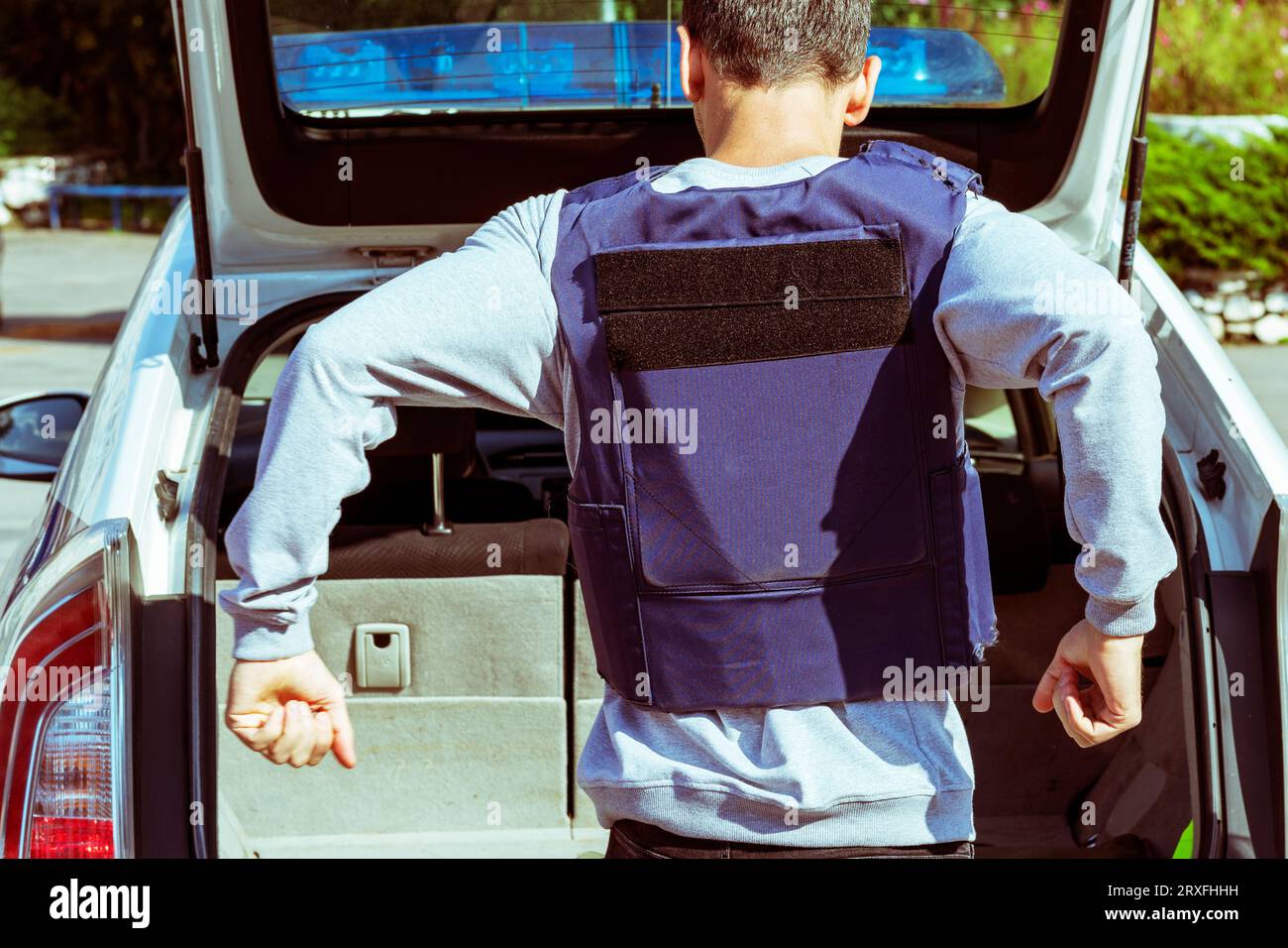 The policeman puts on a protective vest before the combat mission and ...