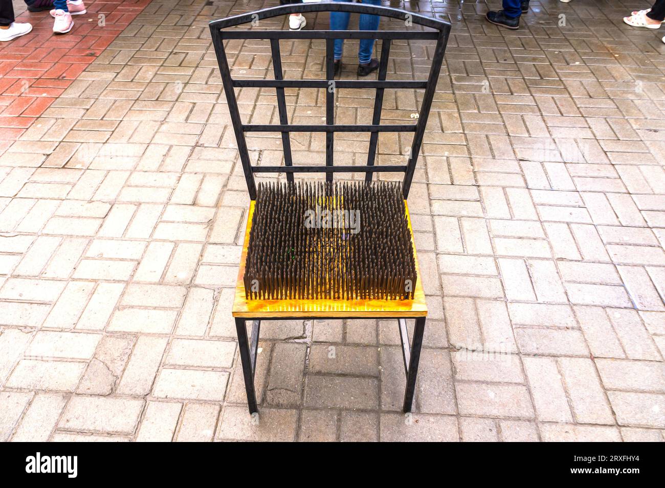 wooden chair medieval torture with nails in the back, seat and armrests ...