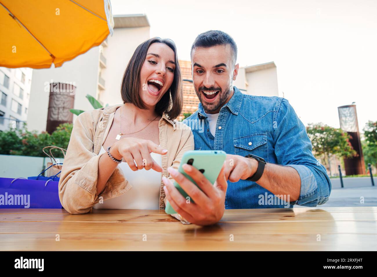 Couple sharing mobile phone having hi-res stock photography and images ...
