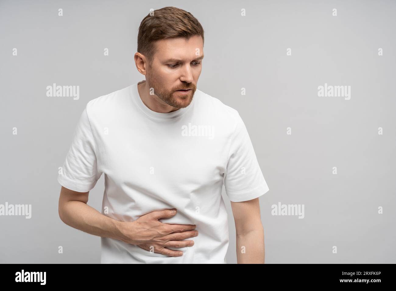 Man holds on to sore stomach. Nausea, gastritis, acute pain intestines ...