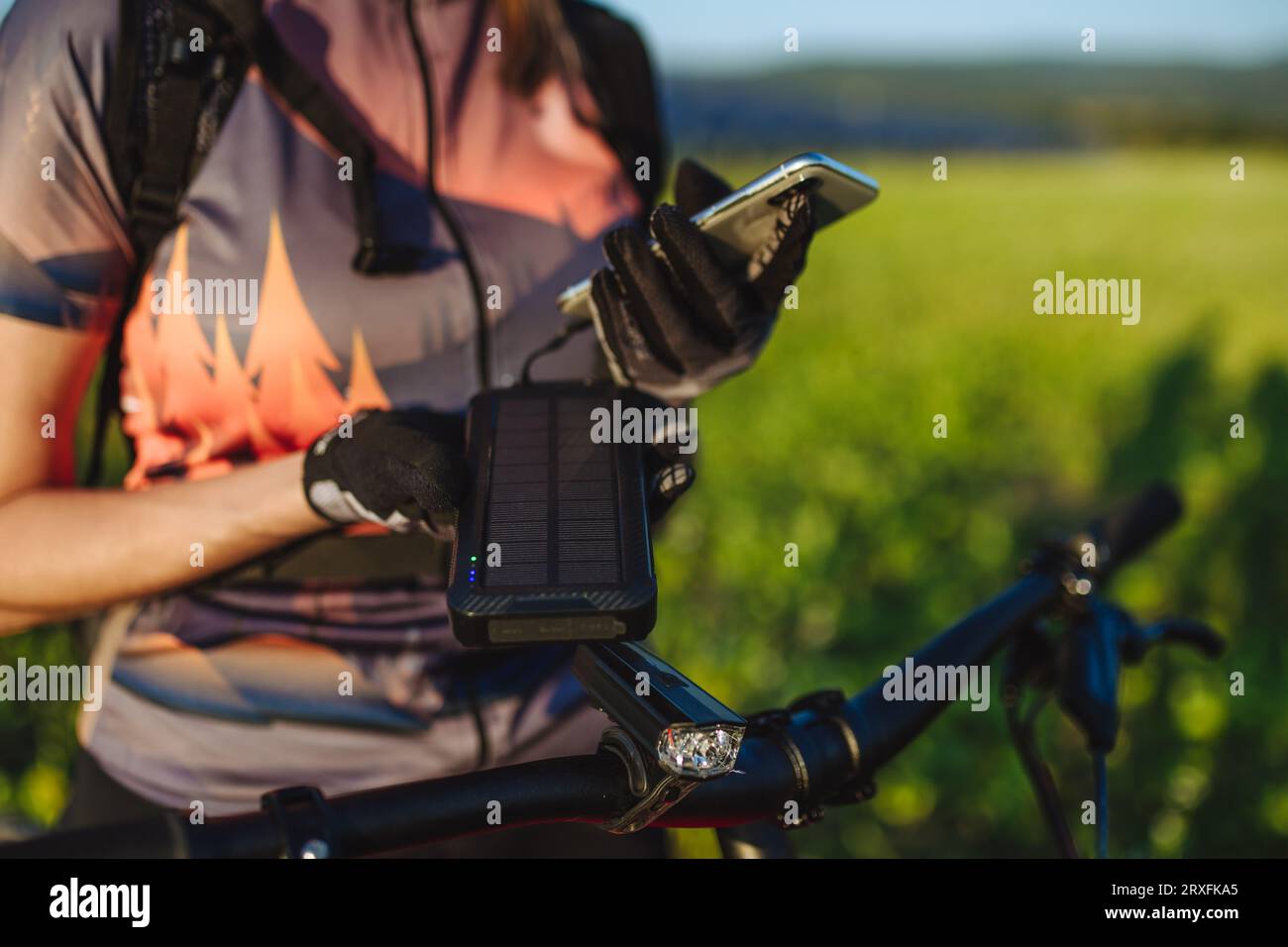 Cyclist charging her smartphone using a solar phone charger Stock Photo ...