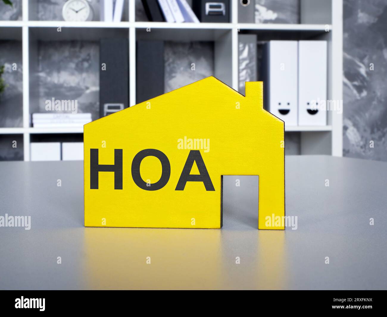 A Yellow model of house with Homeowners Association HOA inscription ...