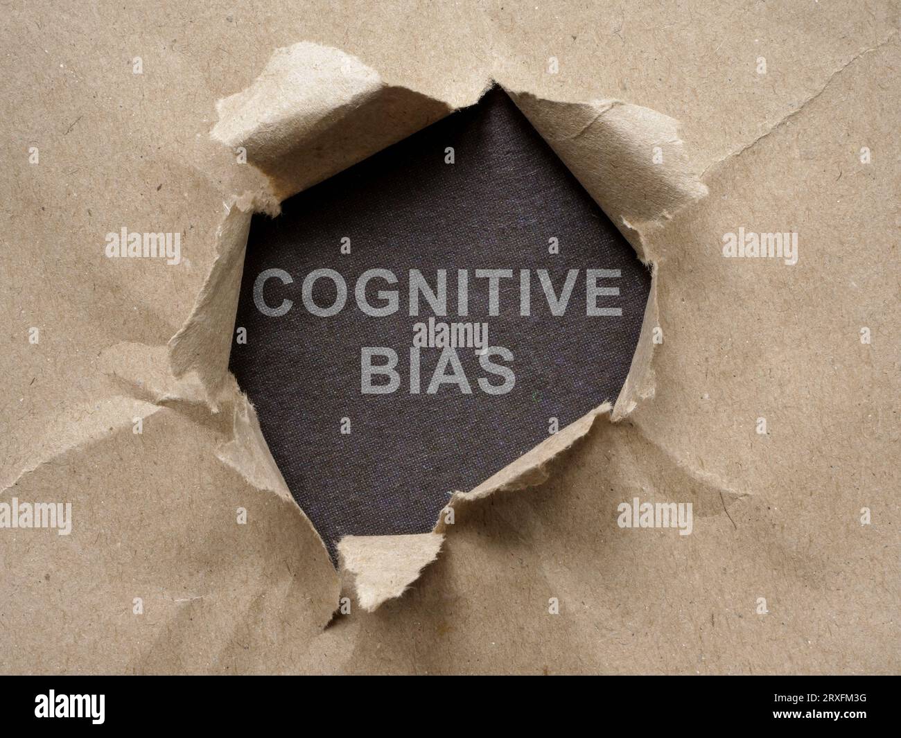 Torn piece of paper with an inscription Cognitive bias Stock Photo - Alamy