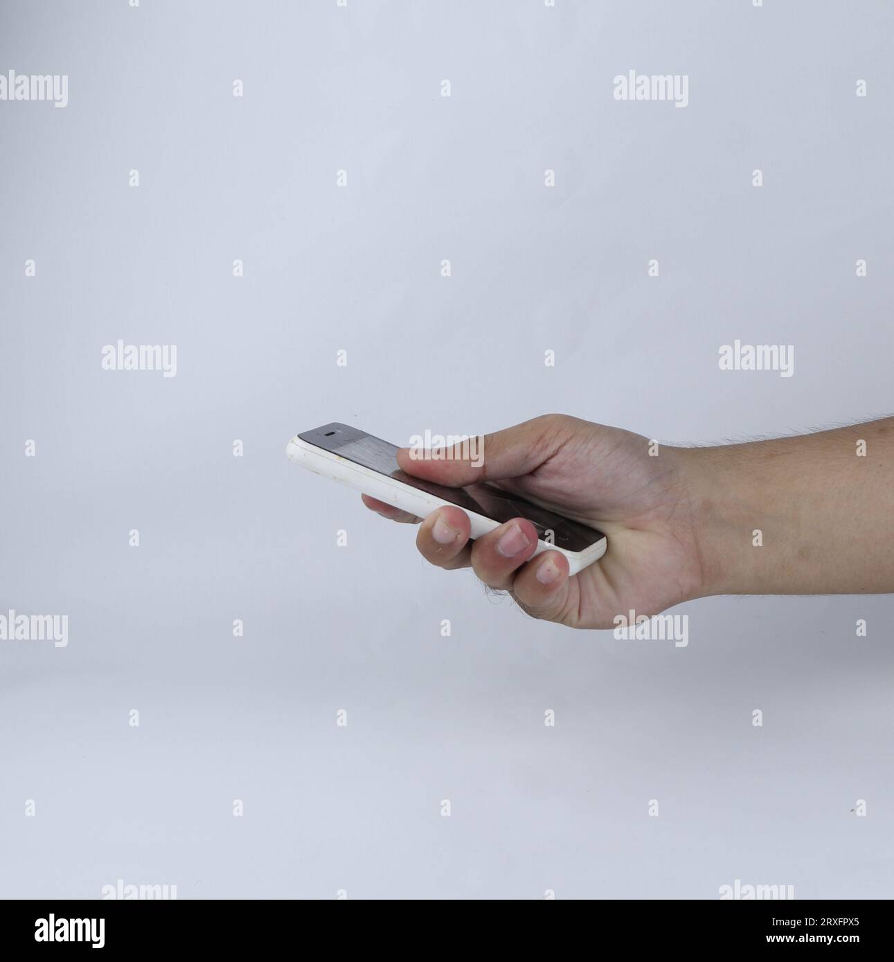 the hand holding the cell phone is broken Stock Photo - Alamy