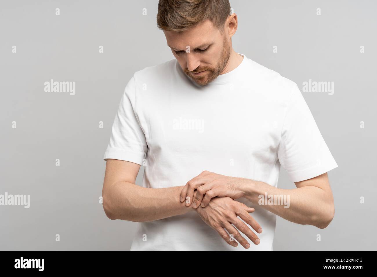 Man touching wrist of hand feeling pain on gray background. Tunnel ...