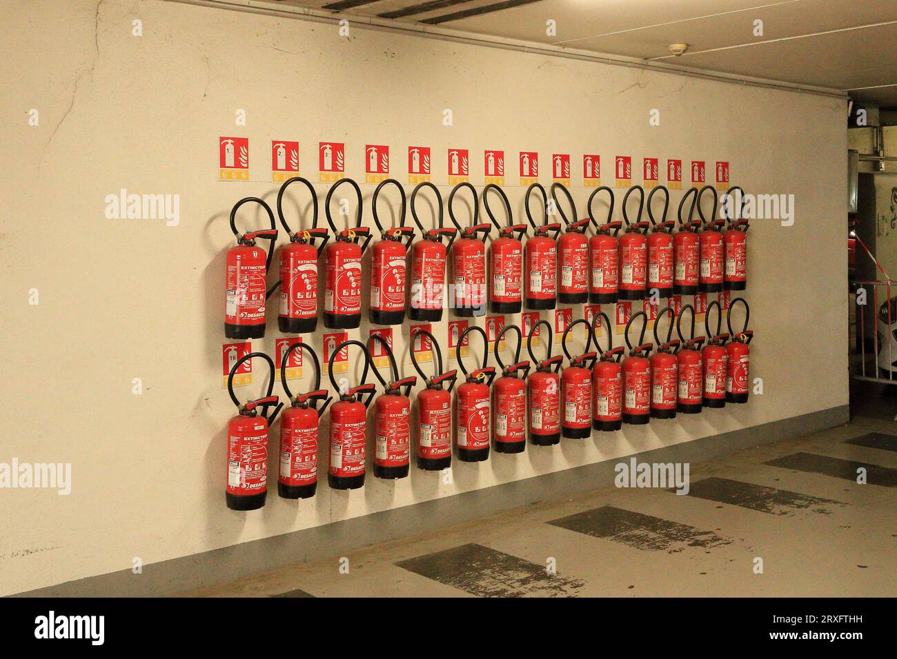 many red Fire Extinguishers at wall Stock Photo - Alamy