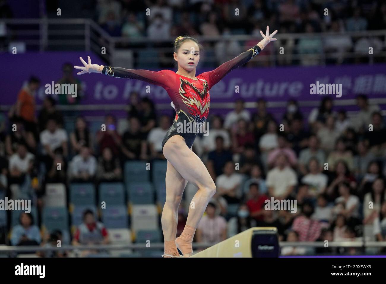 Zhang Xinyi of China performs on the balance beam at the women's team artistic gymnastics event ...