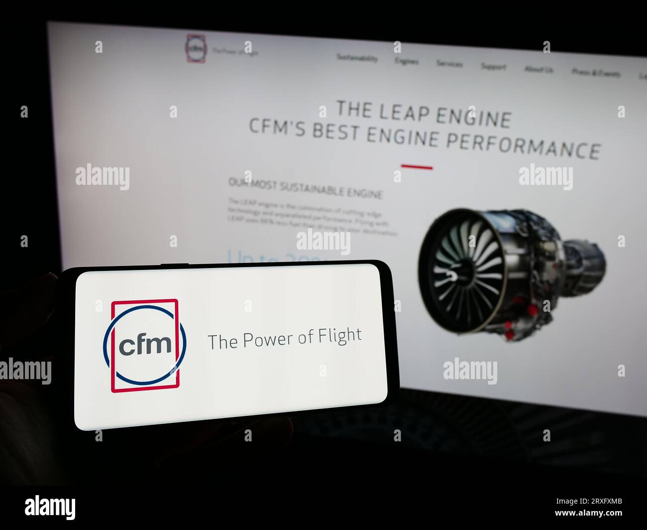 Person holding mobile phone with logo of aircraft engine company CFM ...