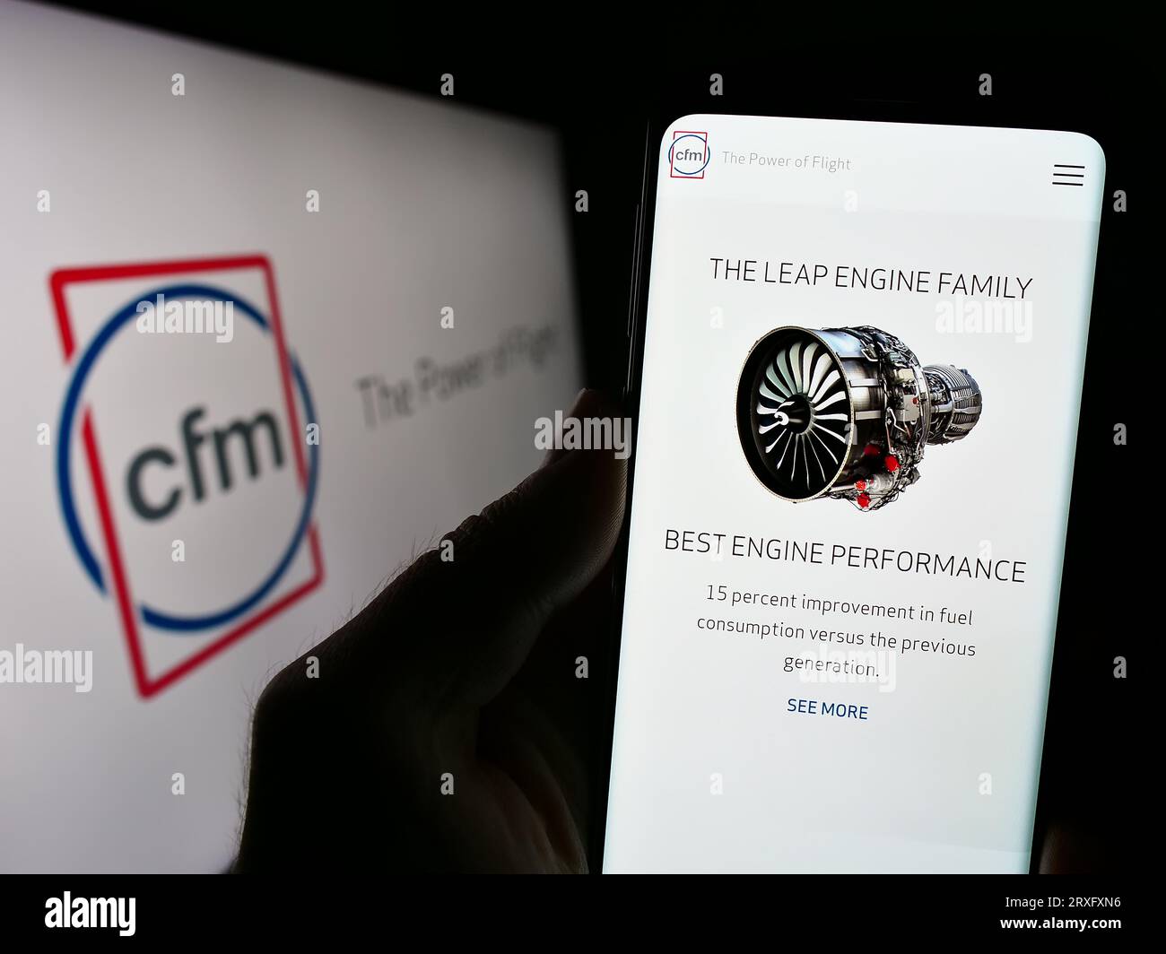 Person holding cellphone with webpage of aircraft engine company CFM ...