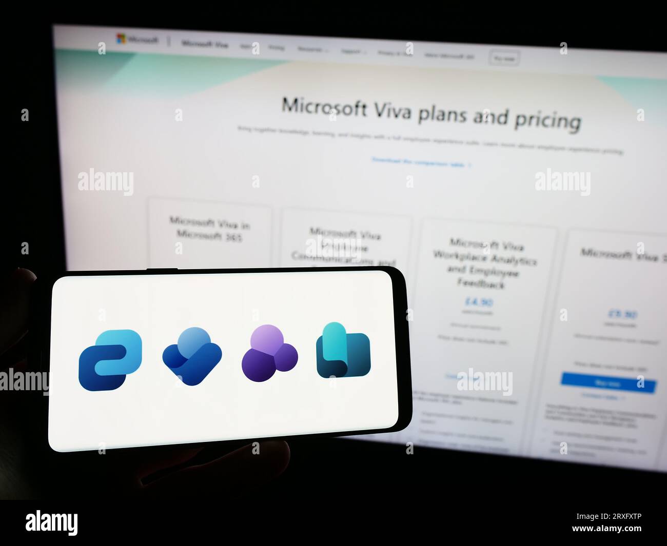 Person holding mobile phone with logo of employee experience platform ...