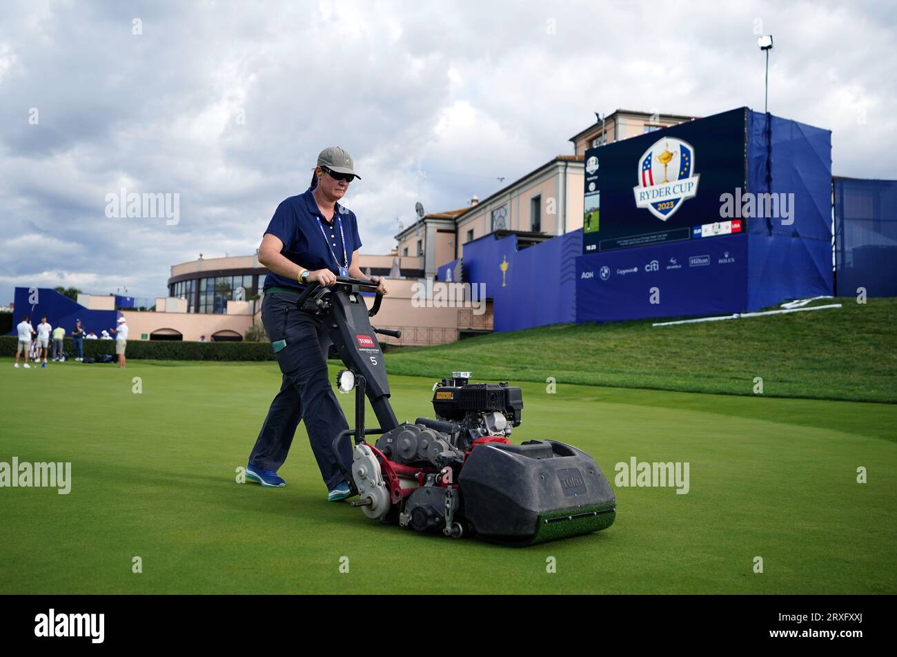 Ground staff mowing the putting green at the Marco Simone Golf and ...