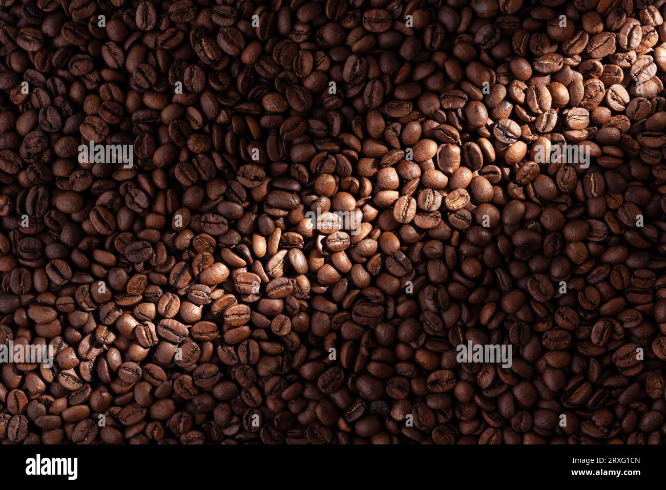 Texture of roasted coffee beans with contrasting dramatic light effect ...