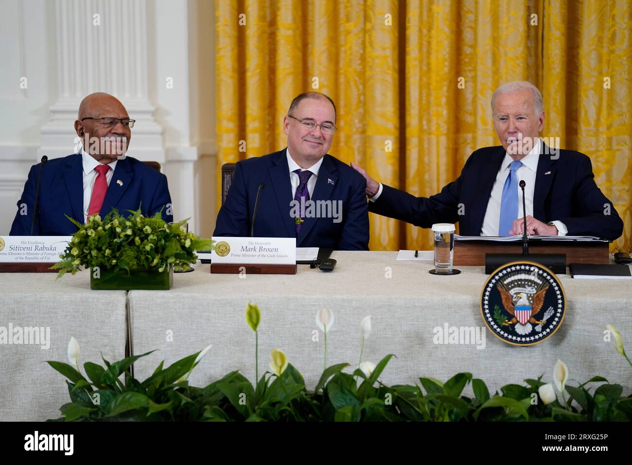 President Joe Biden speaks as he sits next to Cook Islands Prime ...