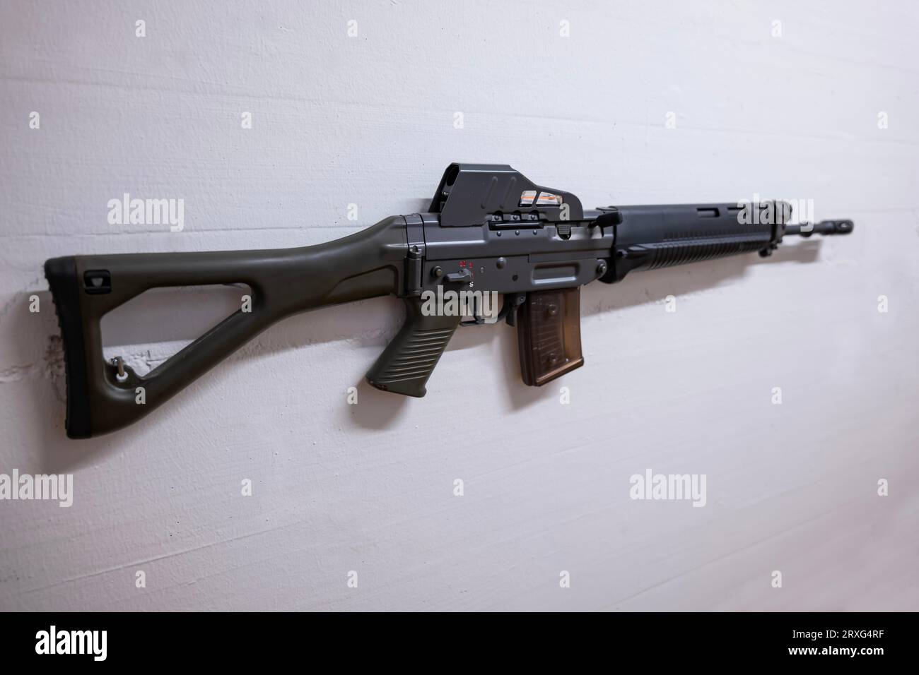 New Modern Machine Gun Hanging on a Wall in Switzerland Stock Photo - Alamy