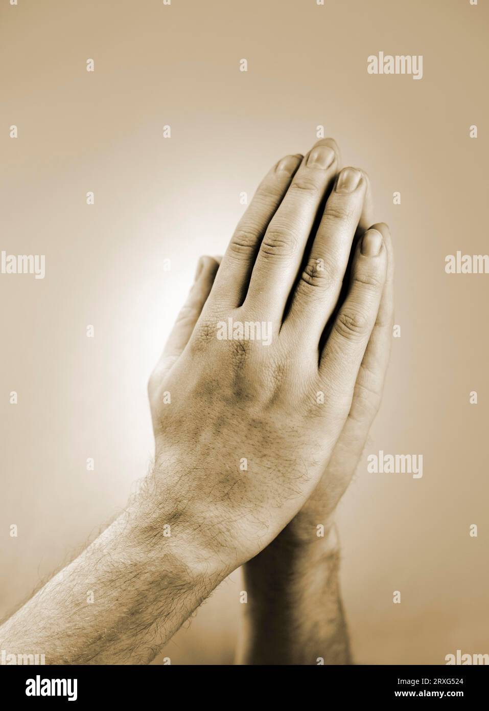 Sepia toned photograph of hand clasped in prayer Stock Photo - Alamy