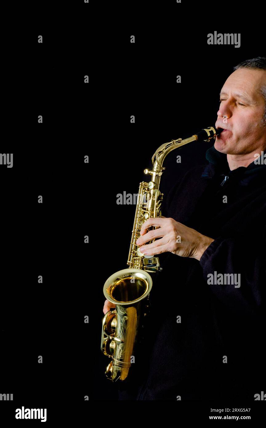 A Musician playing jazz music on his saxophone Stock Photo - Alamy