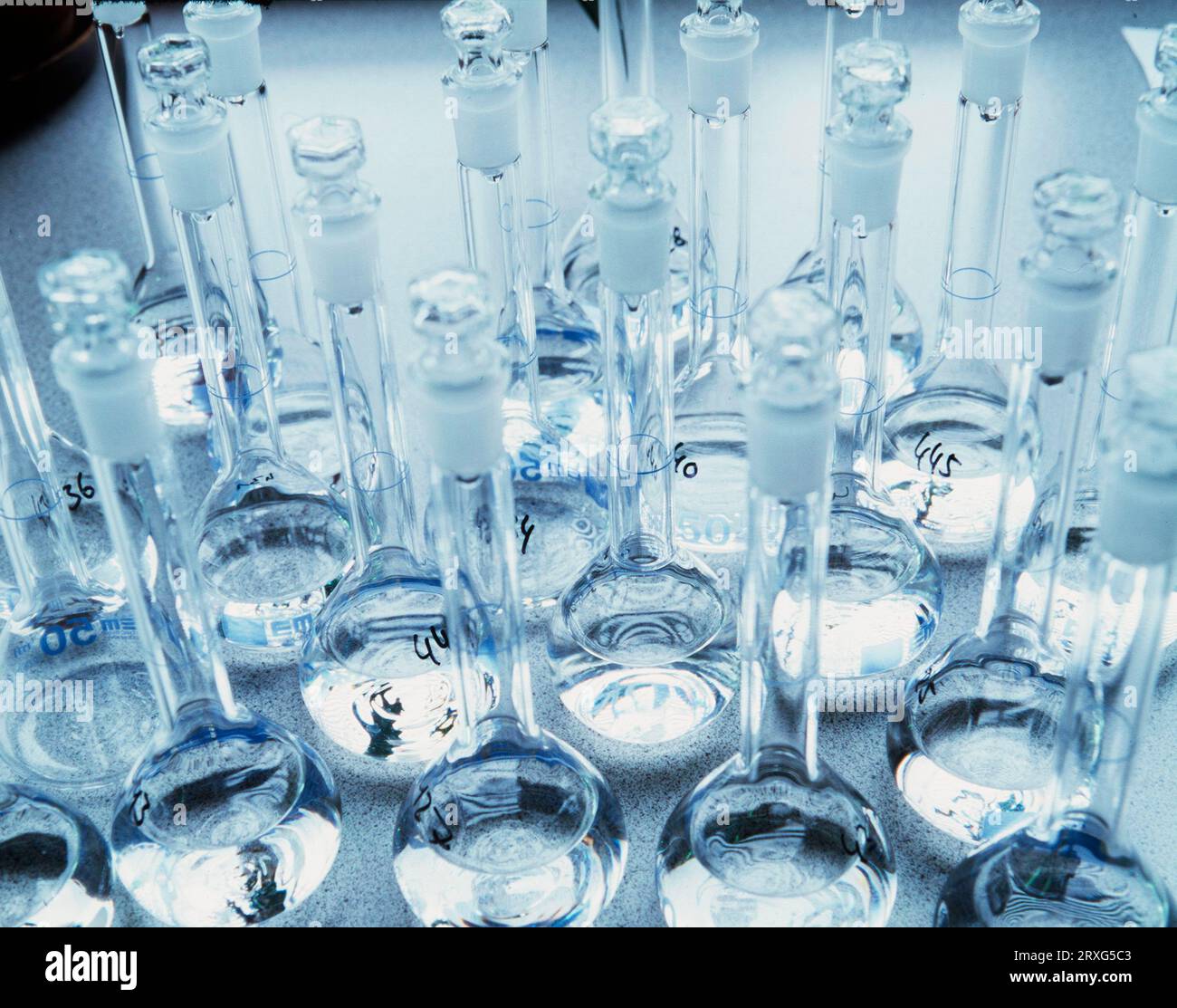 Chemicals in glass laboratory bottles and flasks monochrome, selective ...