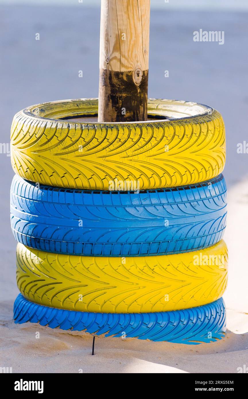 Four blue and yellow tires Stock Photo - Alamy